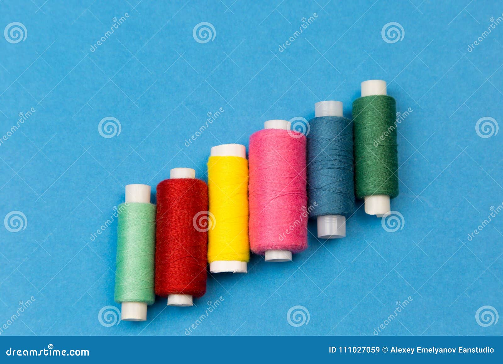 Coils with Multi-colored Threads on a Blue Background. Stock Image ...