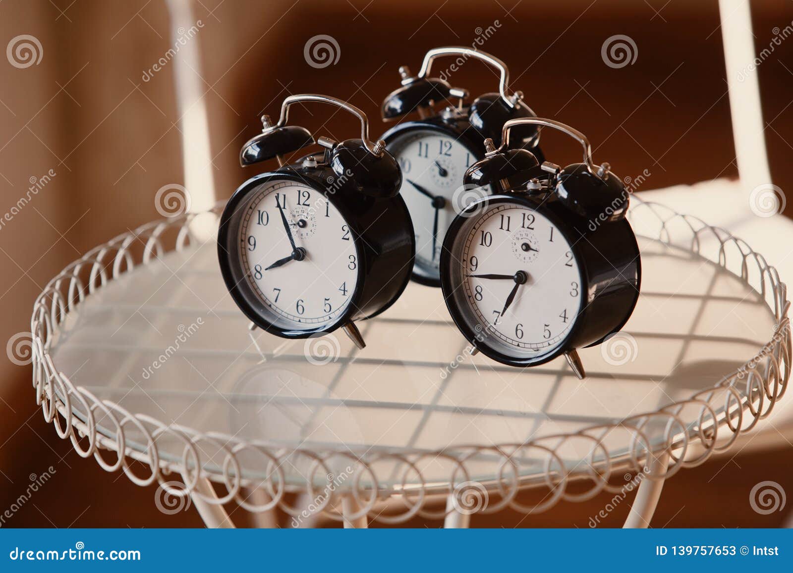 Three Alarm Clocks on Table Stock Image - Image of shiny, hour: 139757653