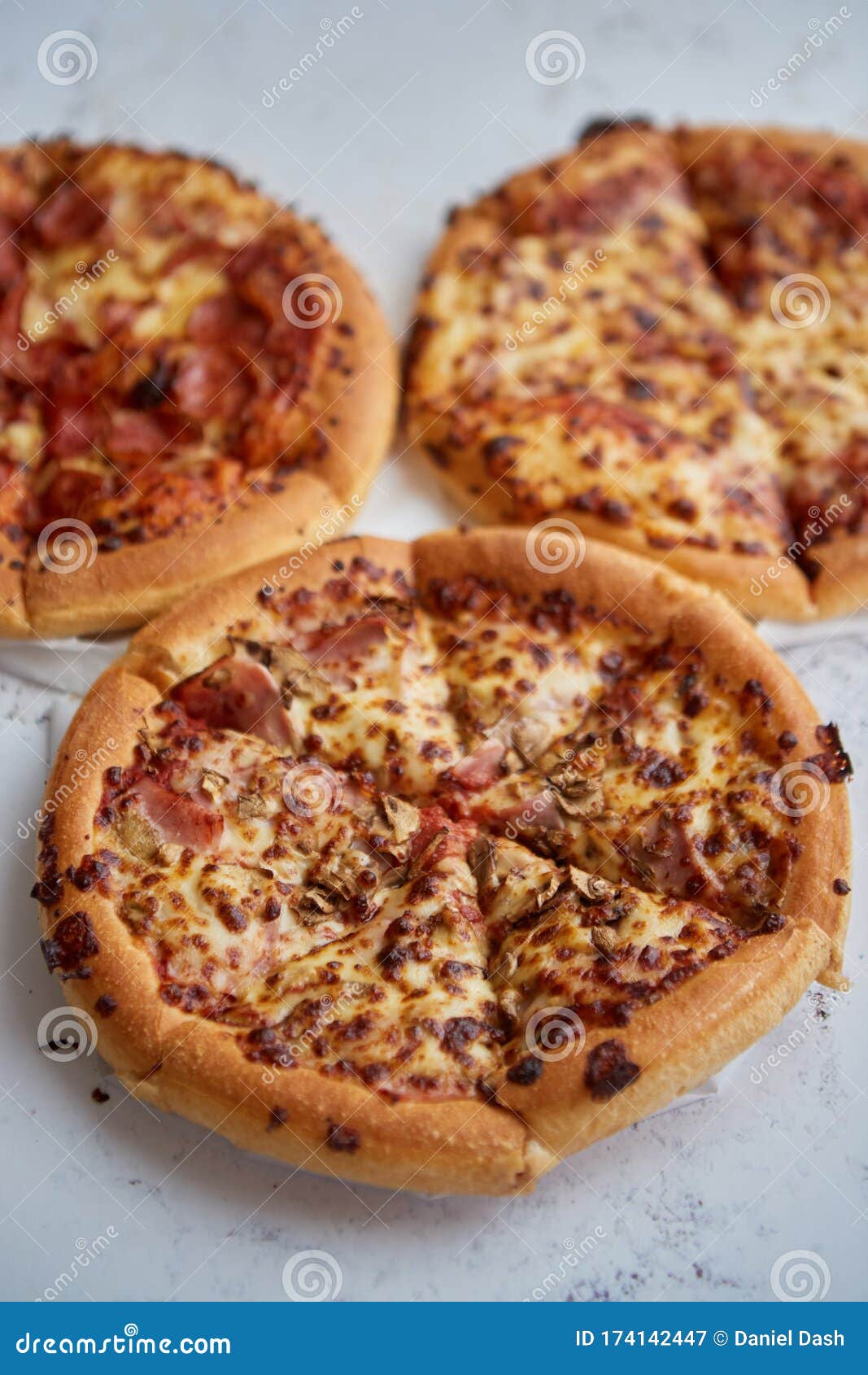 Three American Style Pizzas Served on a Table Stock Image - Image of ...