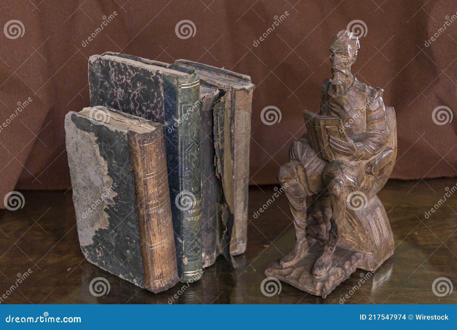 Three Ancient Stained Books by a Statue of a Philosopher Stock Photo ...