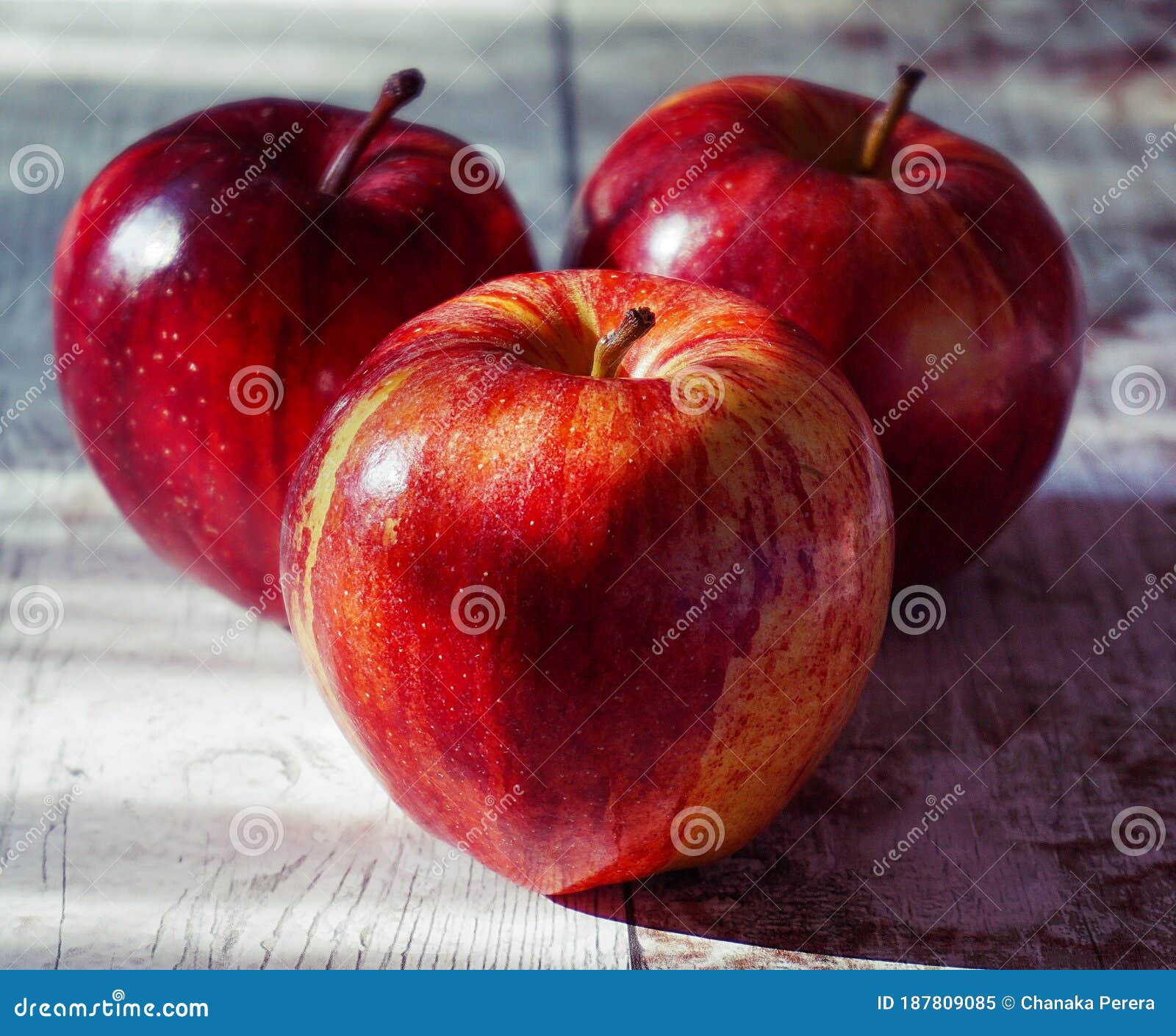 Three apples on the table stock image. Image of food - 187809085