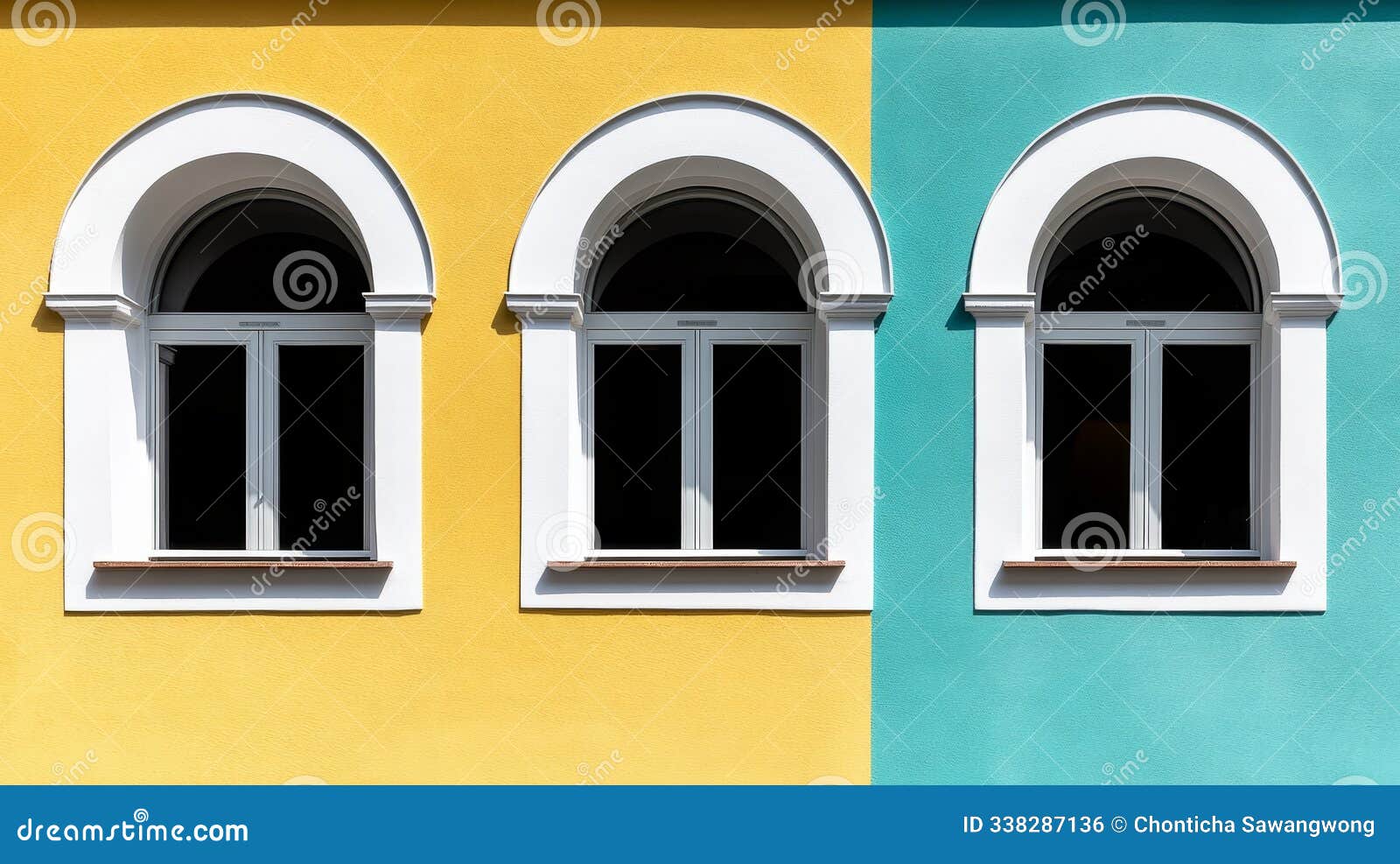 Three Arched Windows with White Frames on a Yellow and Teal Wall Stock ...