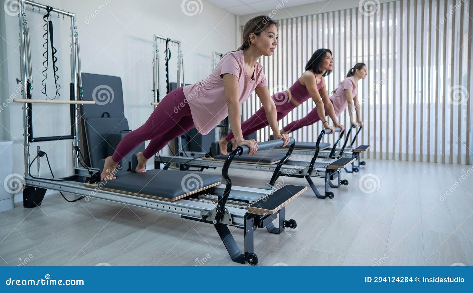 Three Asian Women Doing Plank on Reformer Machine. Stock Photo - Image ...