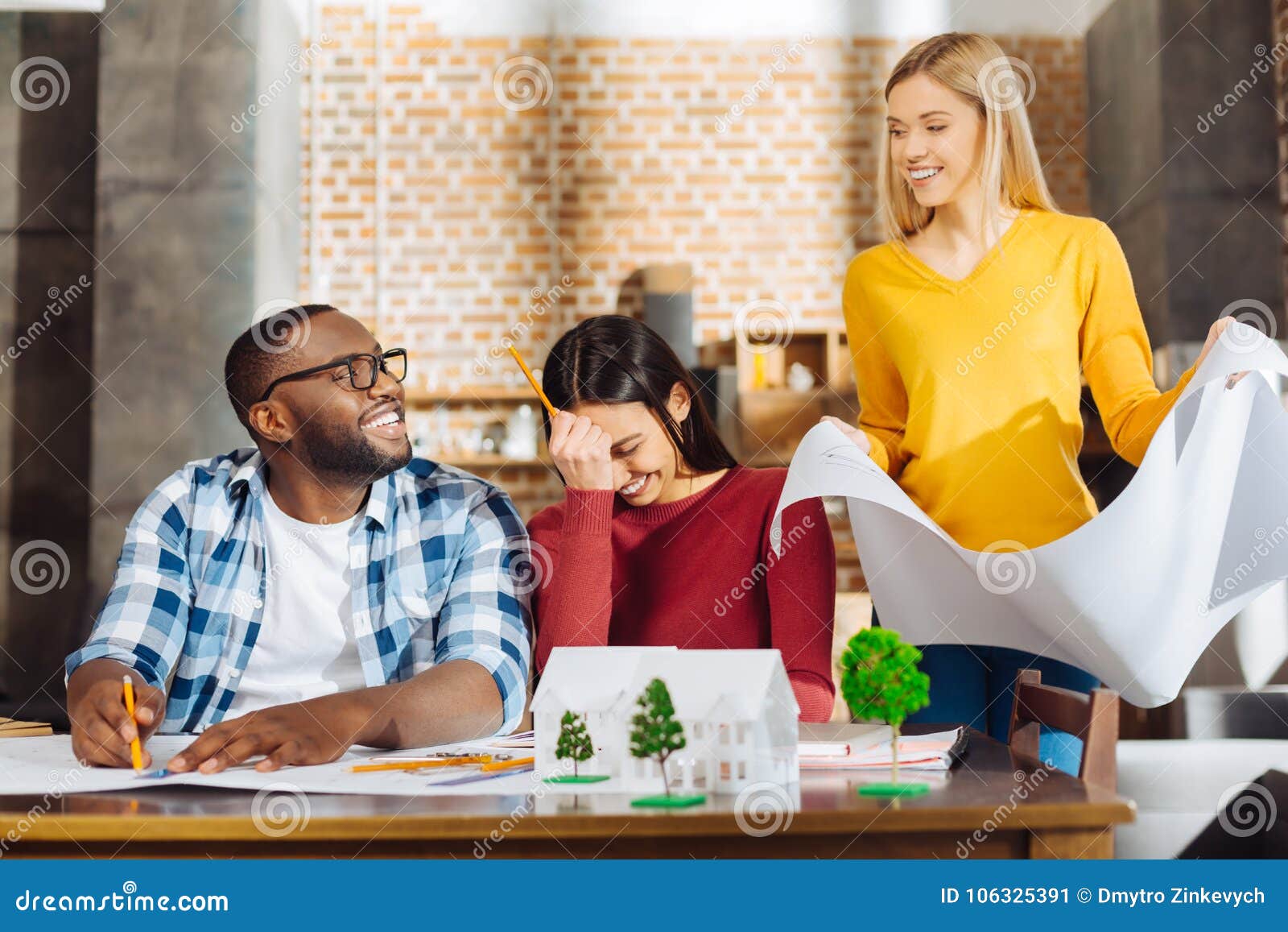 Three Awesome Optimistic Colleagues Working on Project Stock Image ...