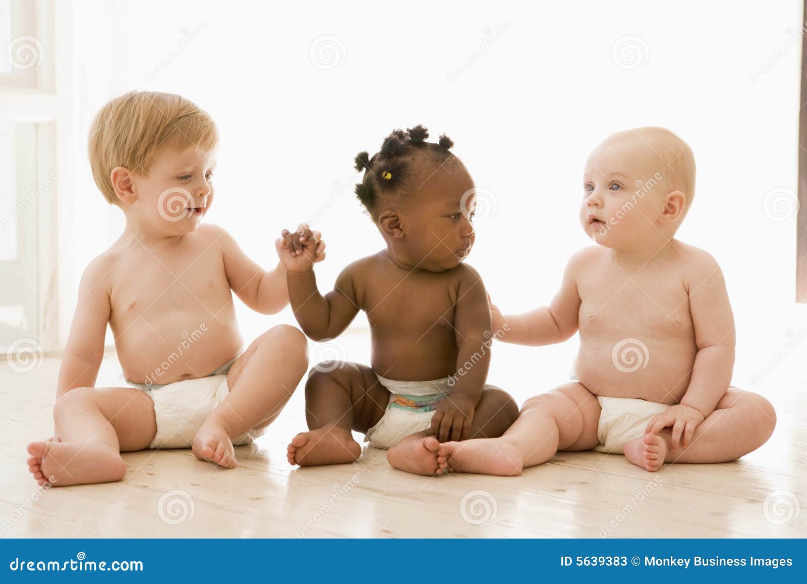 Three Babies Sitting Indoors Holding Hands Stock Image | CartoonDealer ...