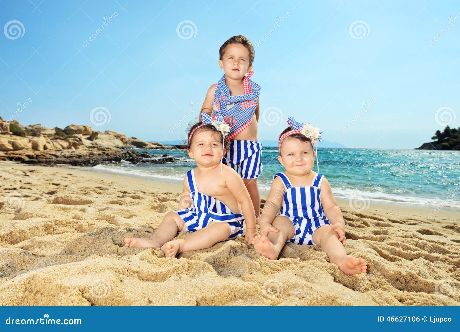 Three Babies Sitting on a Sandy Beach Stock Photo - Image of caucasian ...