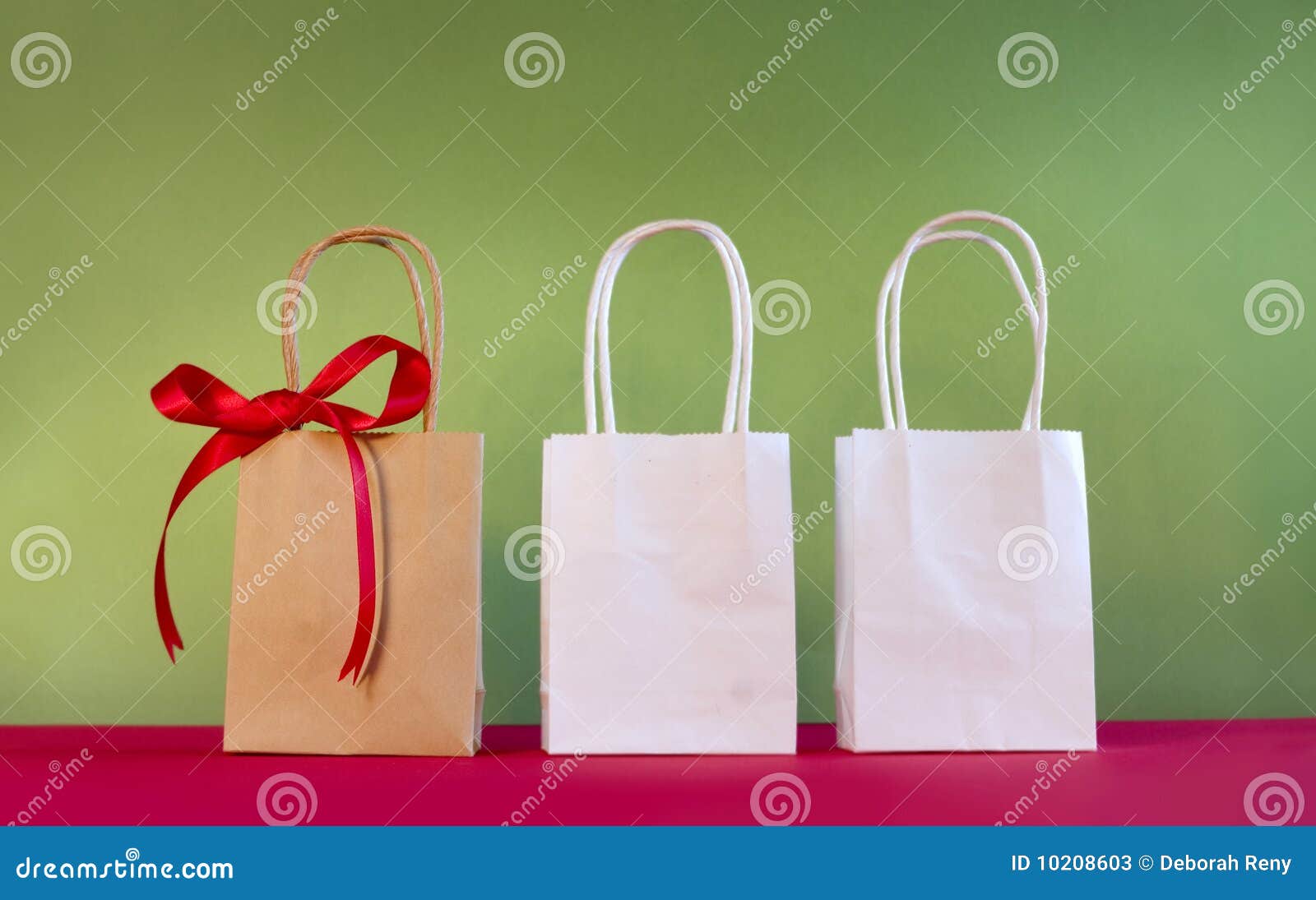 Three Bags Decorated with Bow on Red and Breen Bac Stock Image - Image ...