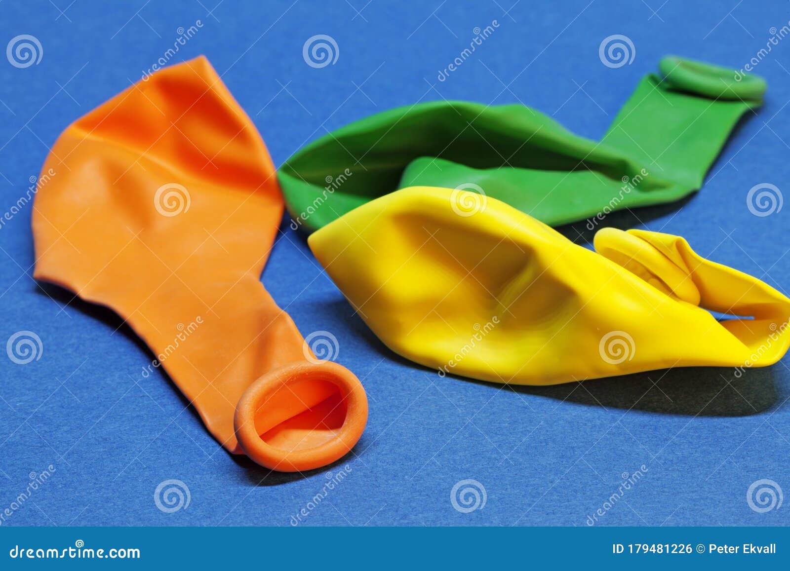 Three Balloons that are Not Inflated on Blue Background Stock Photo ...