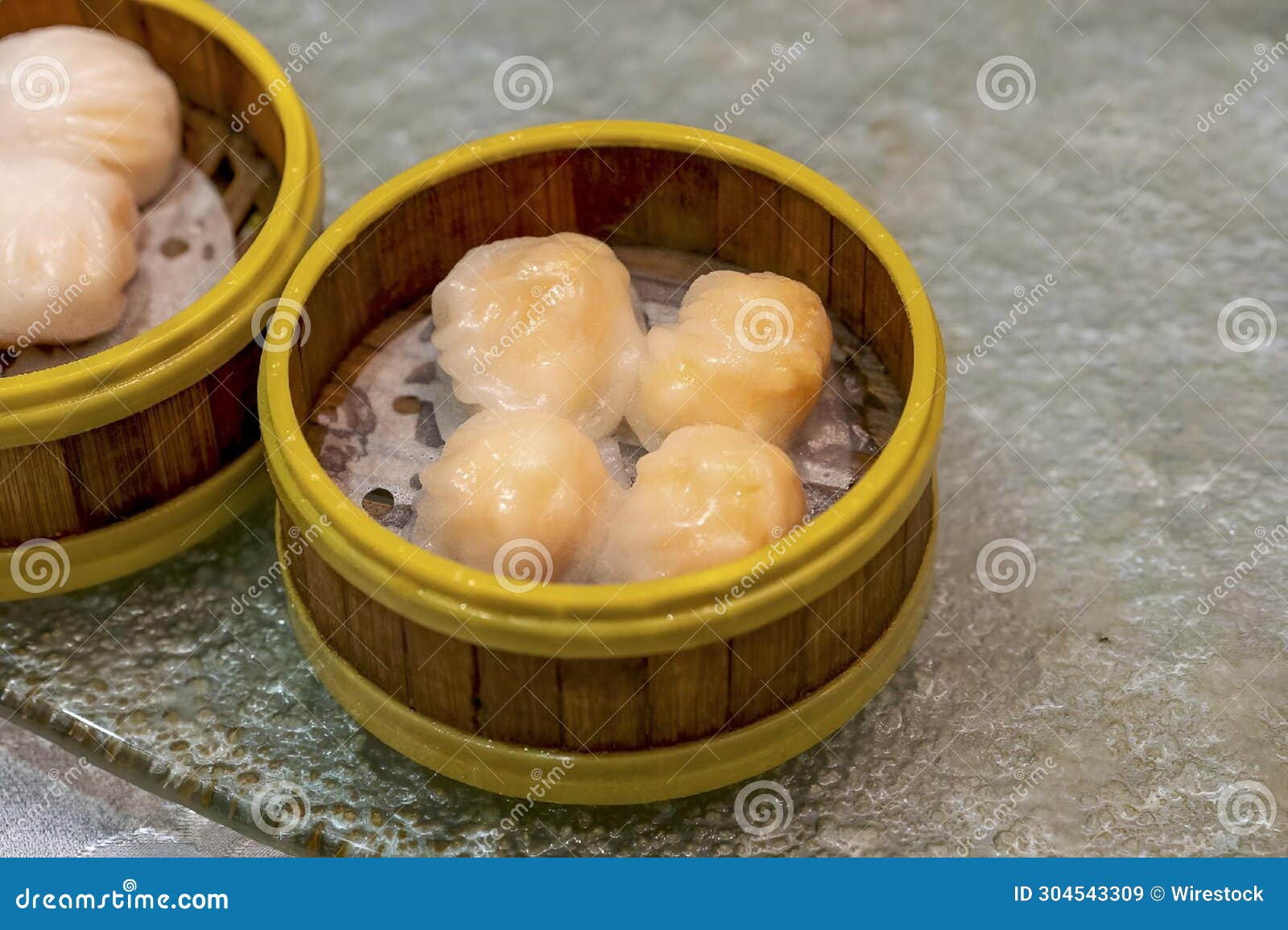Three Dumplings in Bamboo Baskets Sitting on Top of a Counter Stock ...