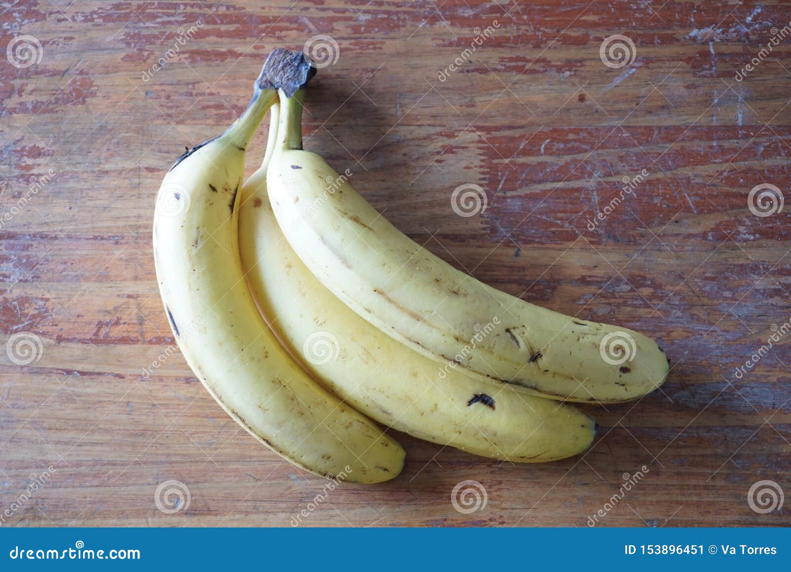 Three bananas on a table stock image. Image of brown - 153896451