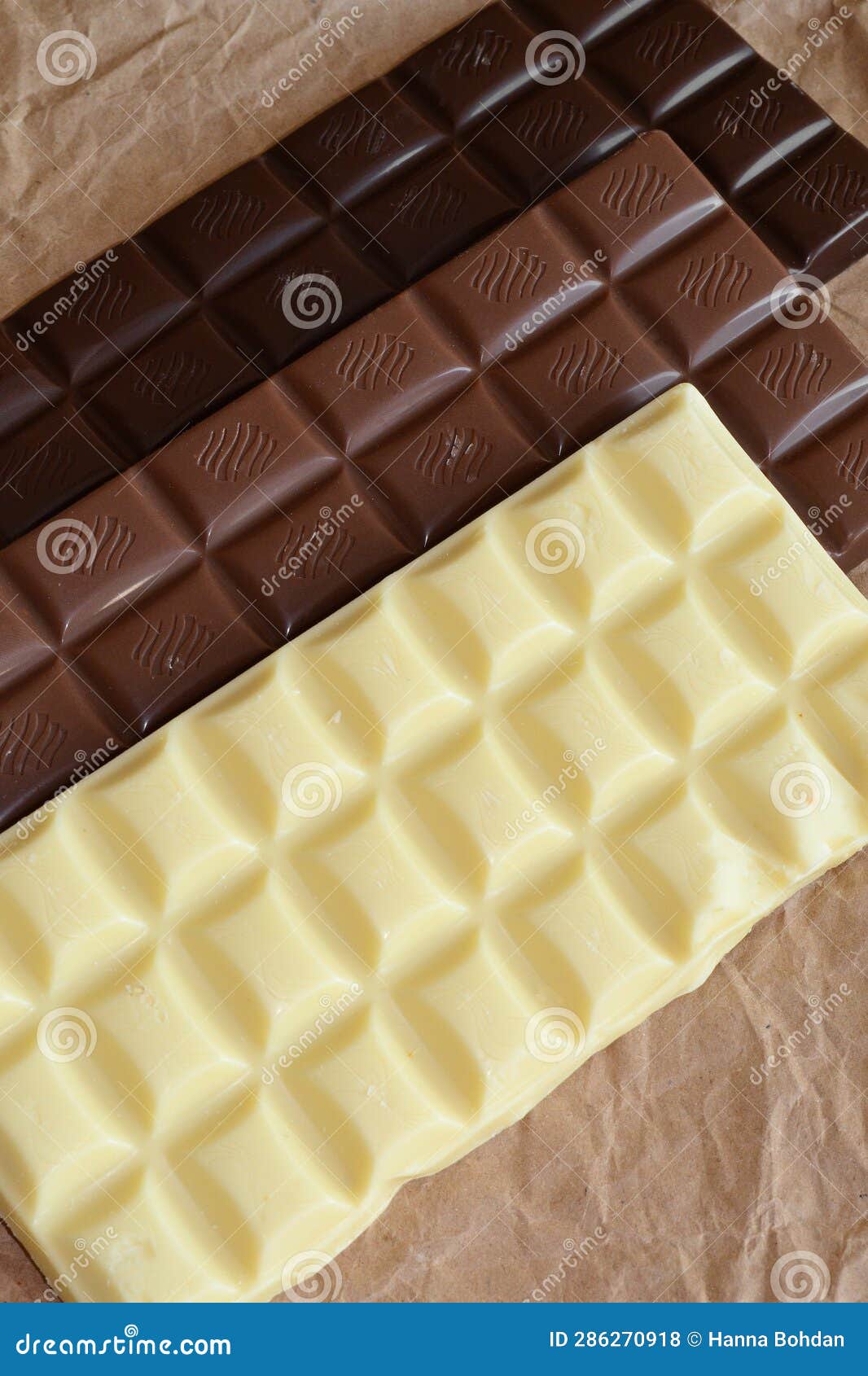Three Bars of Chocolate Lie on the Paper Stock Photo - Image of meal ...
