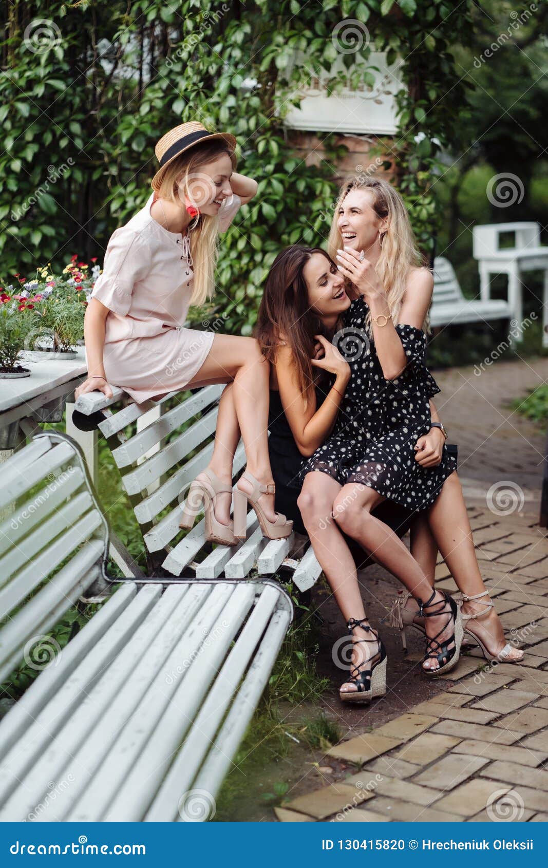 Three girls on the bench stock photo. Image of model - 130415820