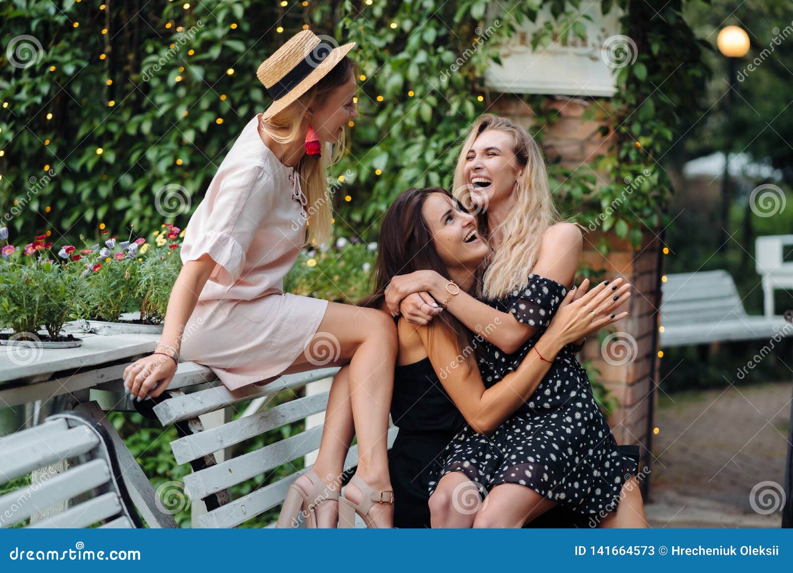 Three girls on the bench stock image. Image of model - 141664573