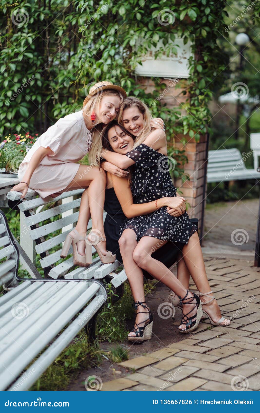 Three girls on the bench stock photo. Image of holiday - 136667826