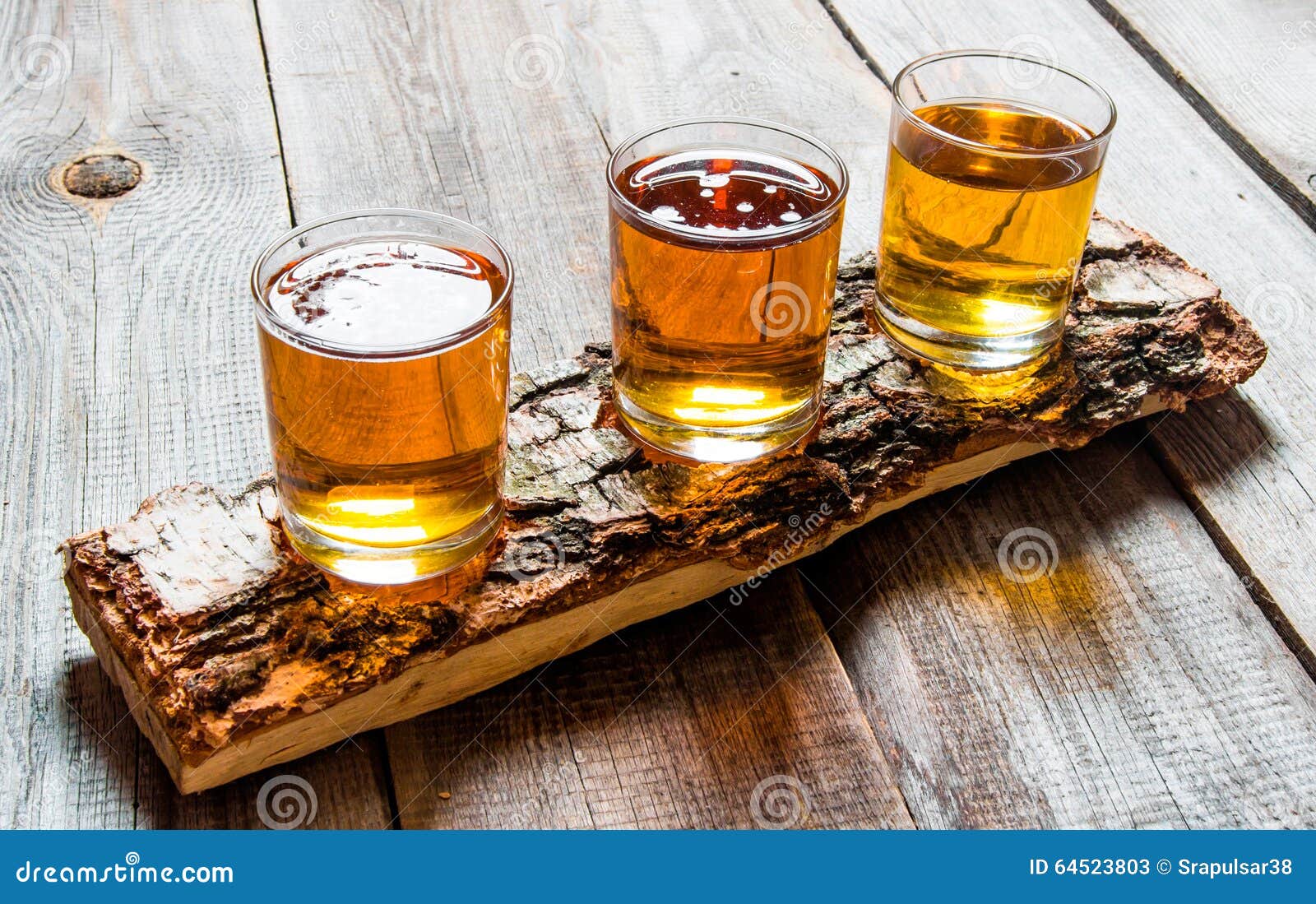 Three Beers on Birch Stand. on a Wooden Table. Stock Image - Image of ...