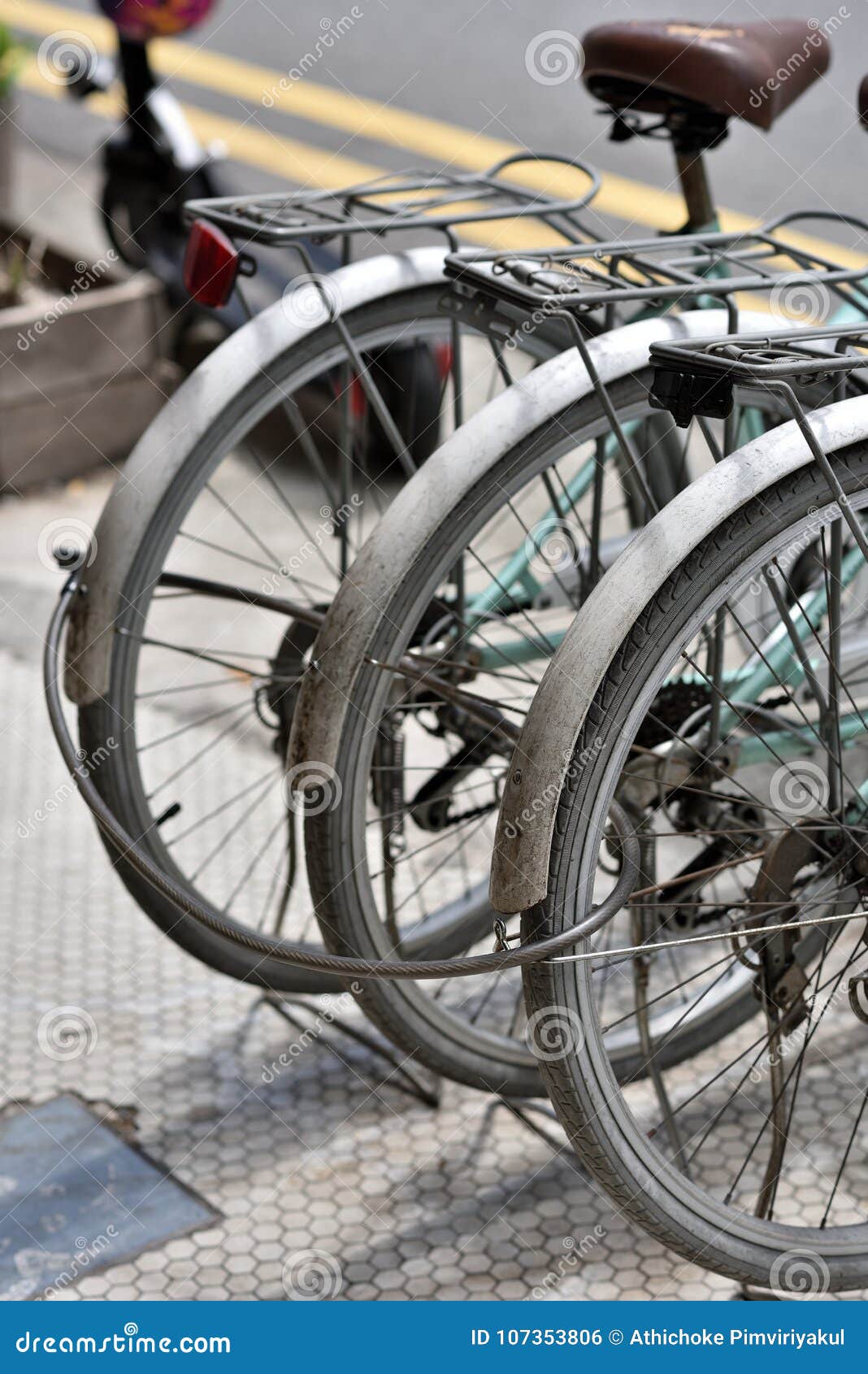 Three Bicycles Tiring Together on Singapore Foot Path Stock Photo ...