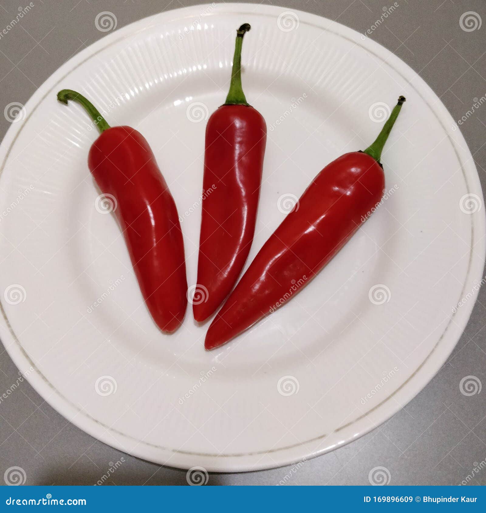 Three Big,fat Bright Red Coloured Serrano Chilli Peppers in a White ...