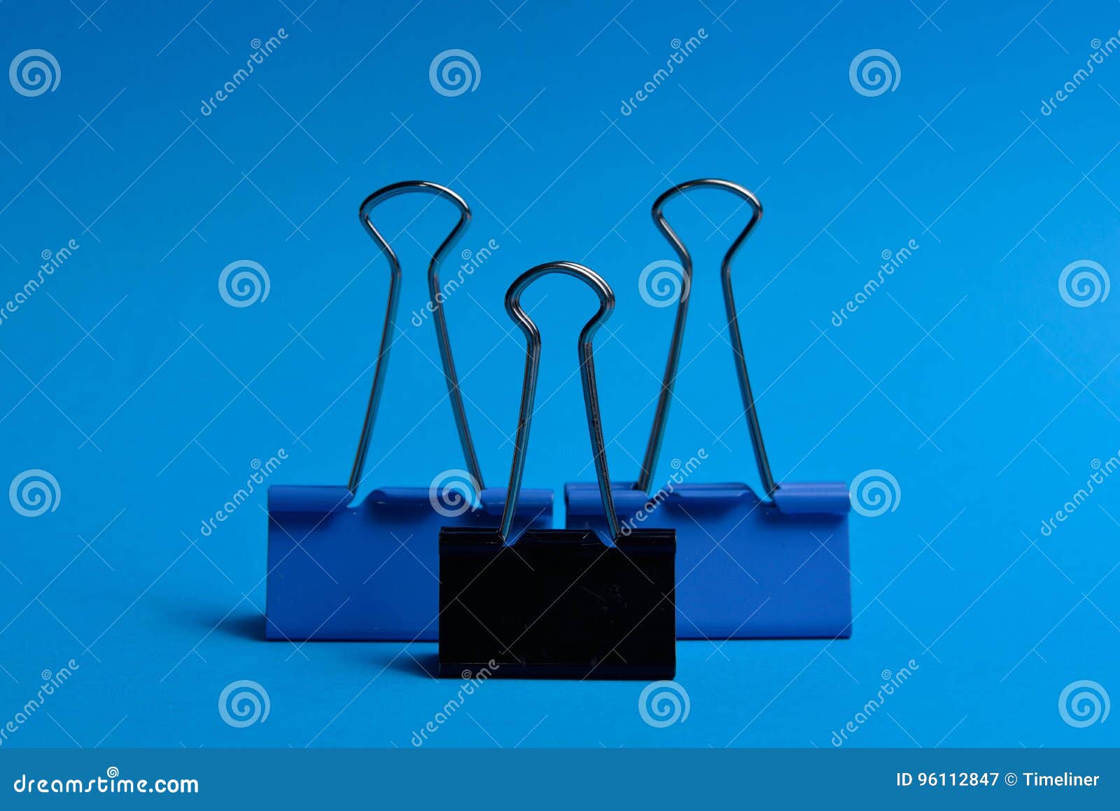 Three Binder Clips on Blue Background Stock Image - Image of paper ...