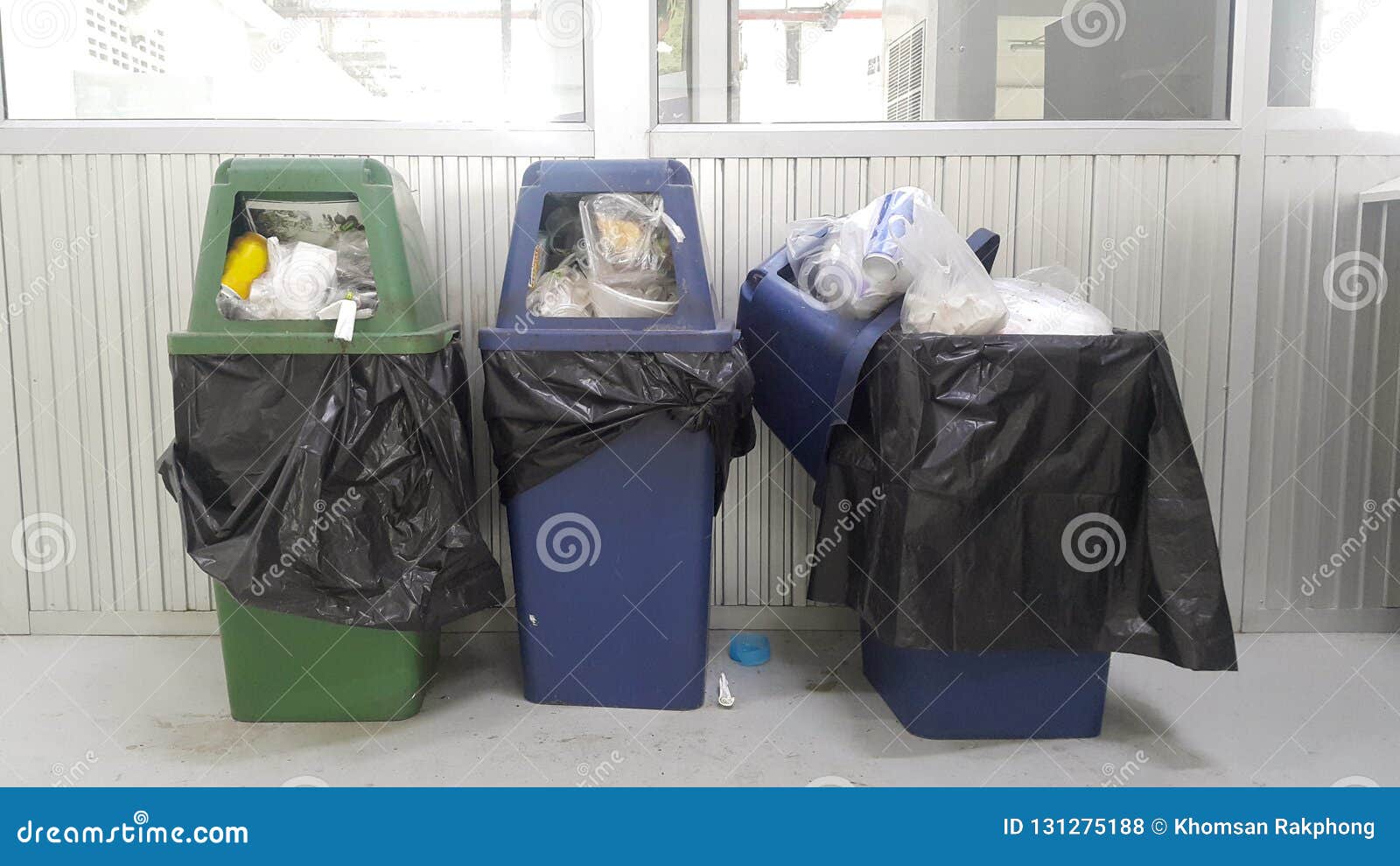 Three Bins Full Of Garbage And Overflowing Outside. Stock Photo ...