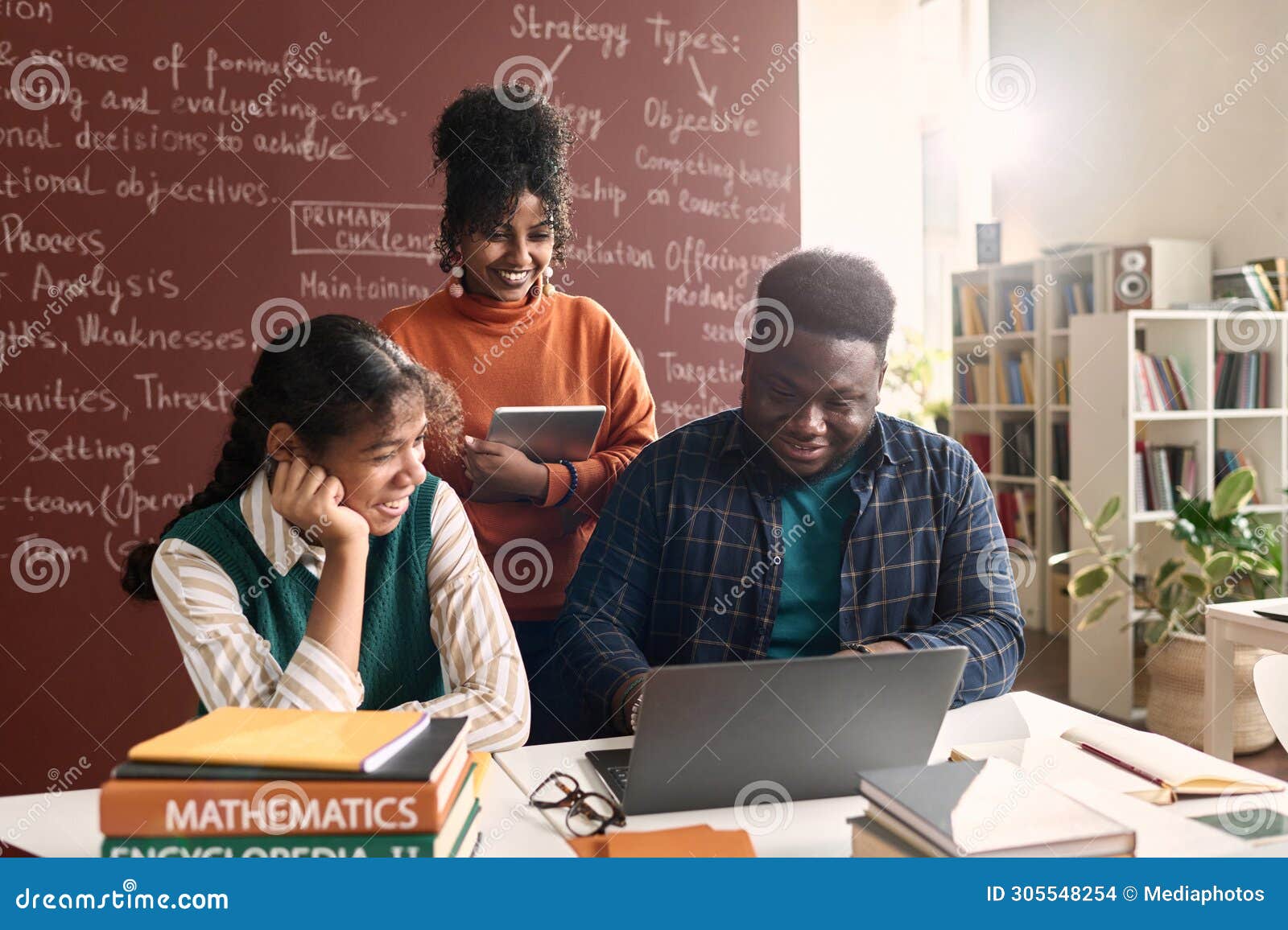 Three Black College Students Looking at Laptop in Class Stock Photo ...