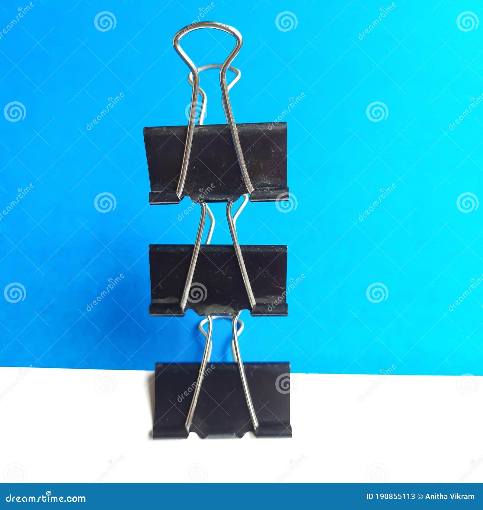 Three Black Paper Clips or Chart Clips Arranged Vertically in White and ...