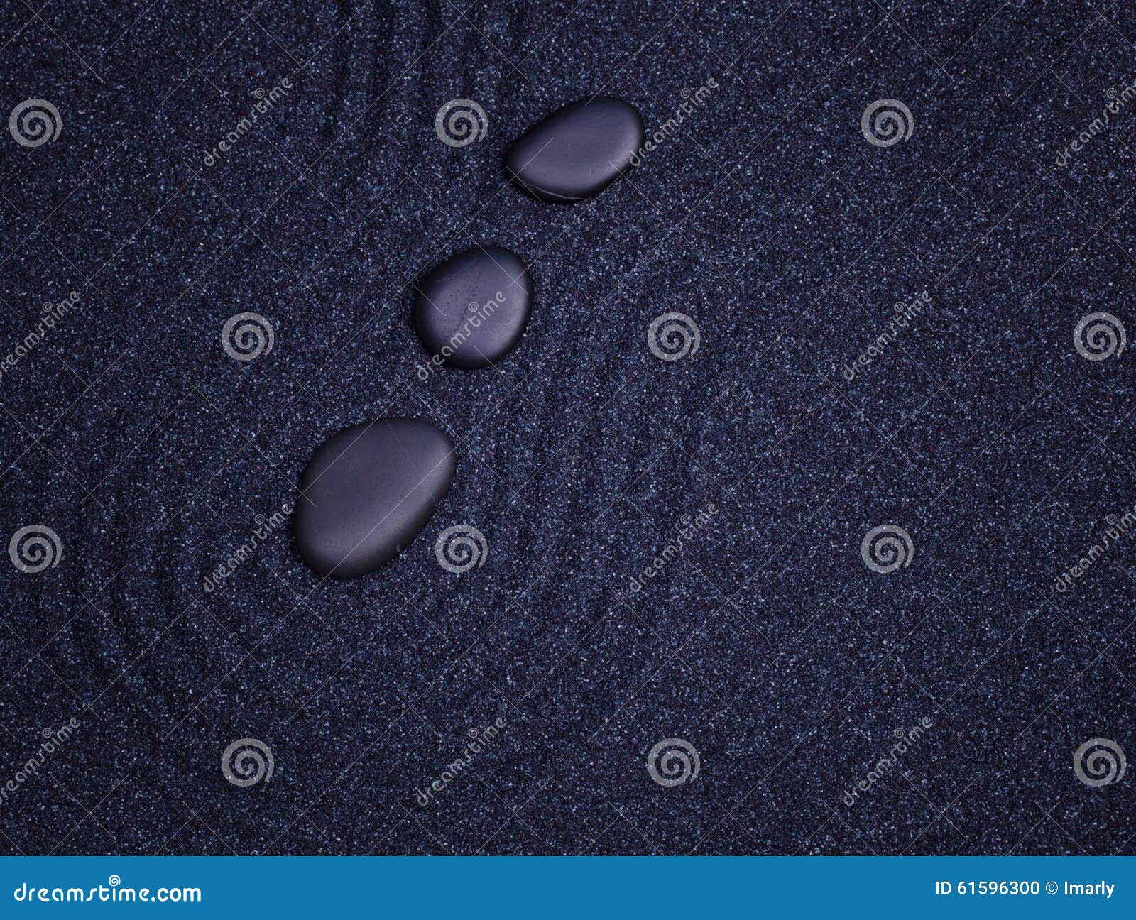 Three Black Stones Aligned in a Straight Line with Waves Stock Photo ...