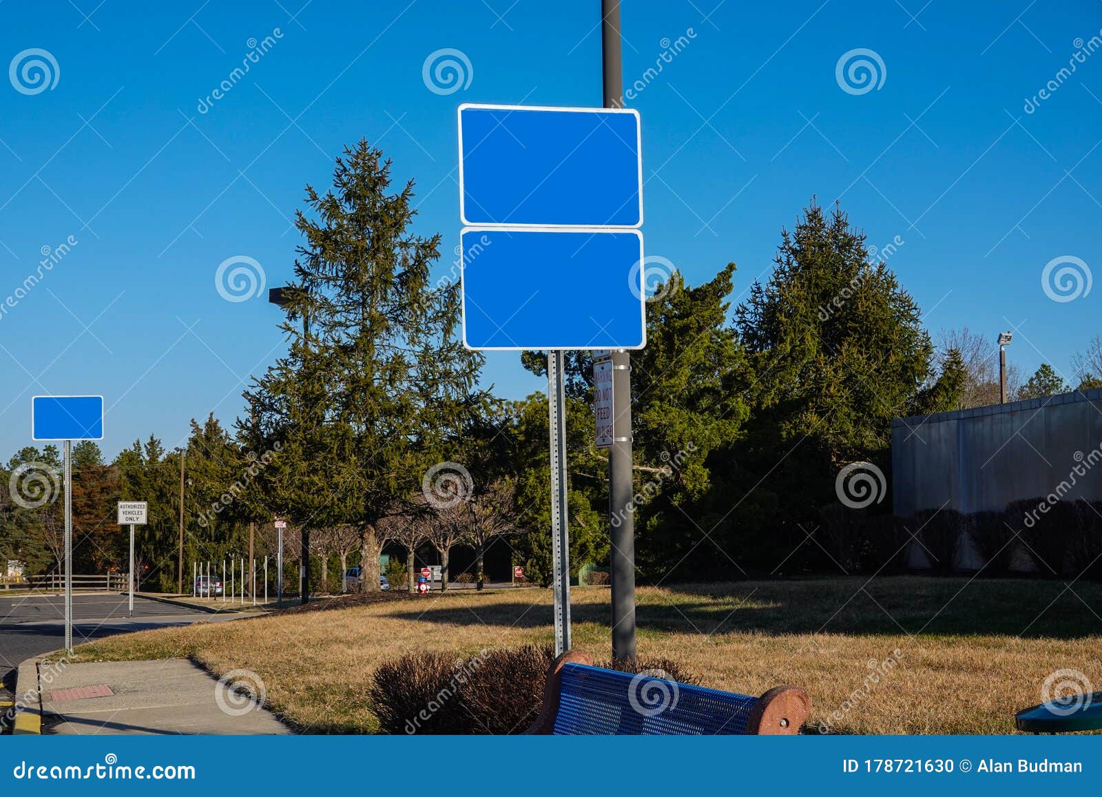 Three Blank Blue Direction Signs Near a Parking Lot. Stock Photo ...