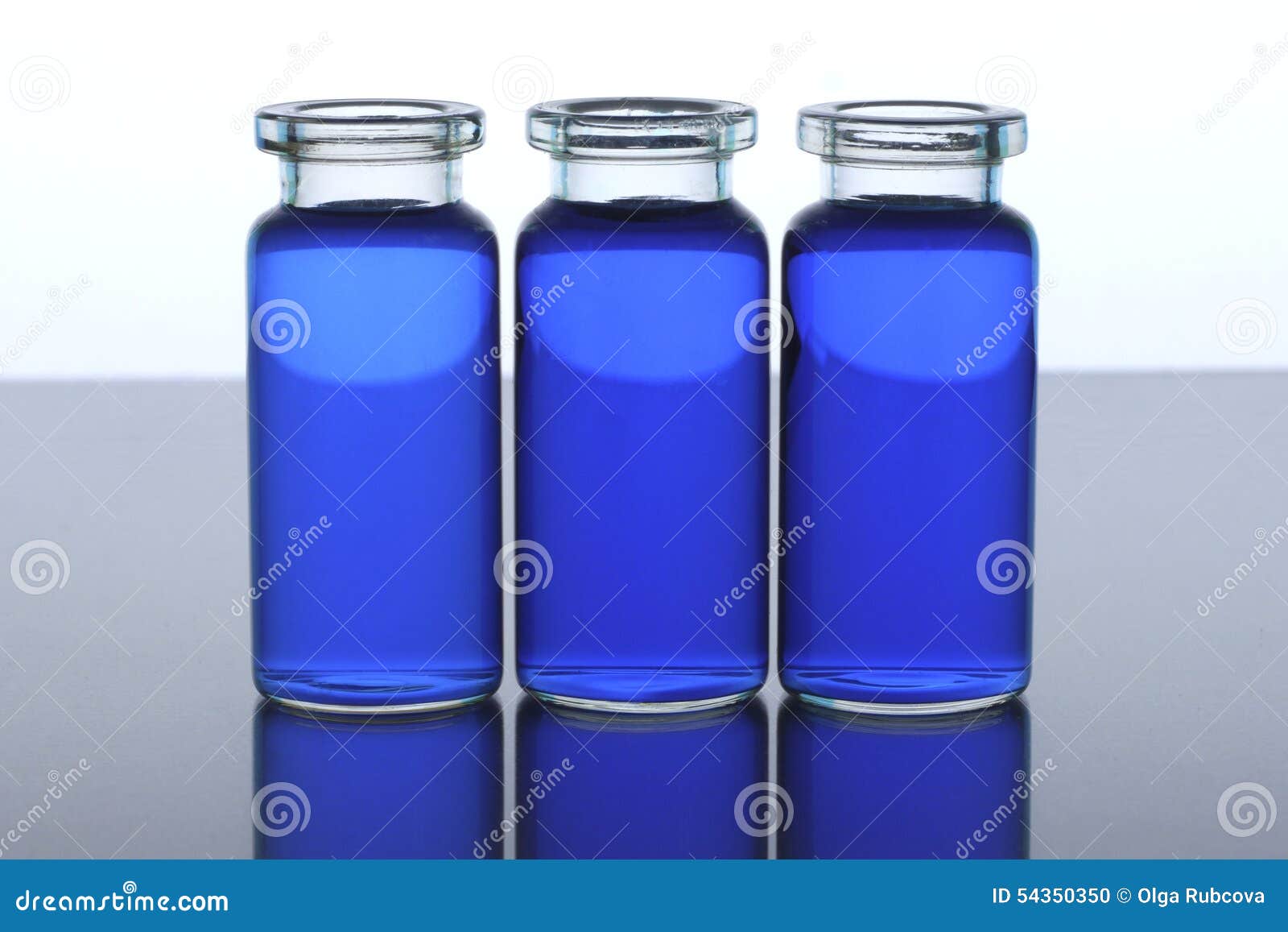 Three Bottles with Blue Liquid Stock Photo - Image of science, white ...