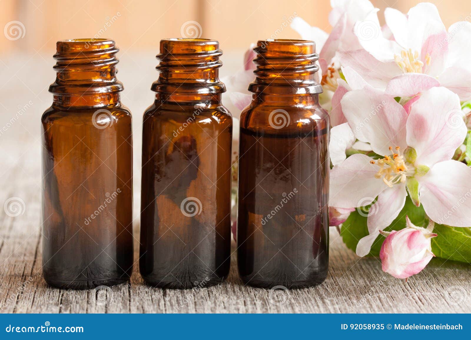 Three Bottles of Essential Oil with Apple Blossoms Stock Image - Image ...
