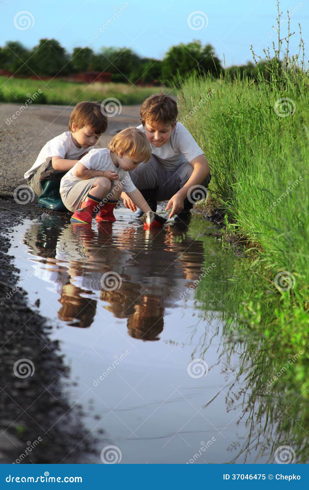 Three boy play in puddle stock image. Image of journey - 37046475