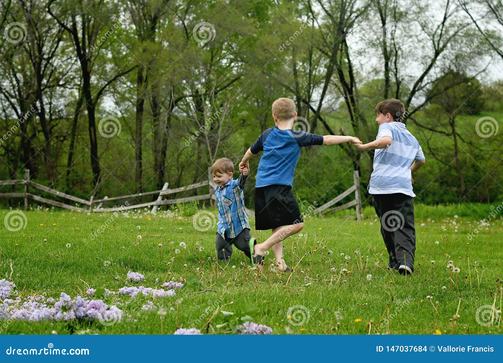 Three Boys Holding Hands Running Stock Photo - Image of three, game ...