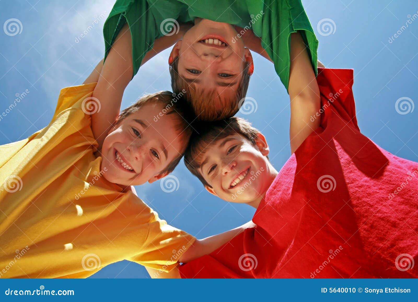Three Boys Huddling stock photo. Image of families, face - 5640010