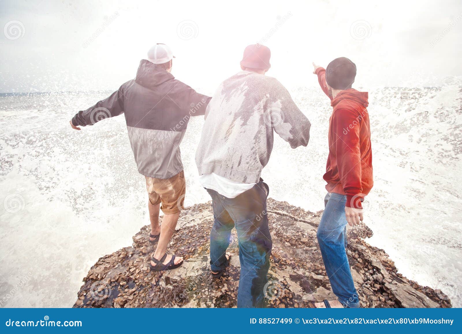 Three Brave Men Standing on a Cliff Stock Image - Image of rock, beach ...