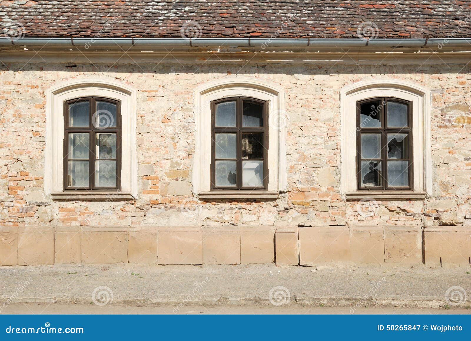 Three Broken Windows in a Wall of a Damaged Building Stock Image ...