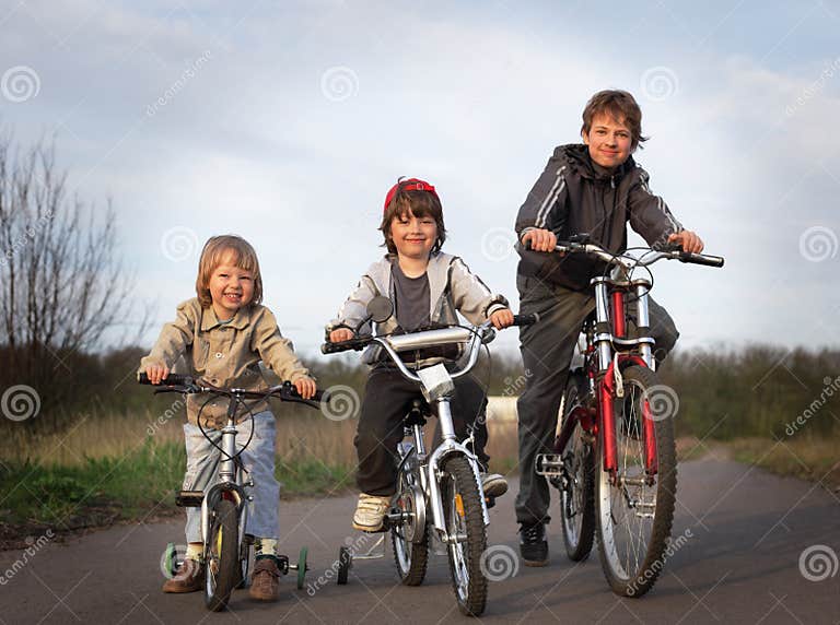 Three brothers ride bikes stock image. Image of outdoors - 40255465