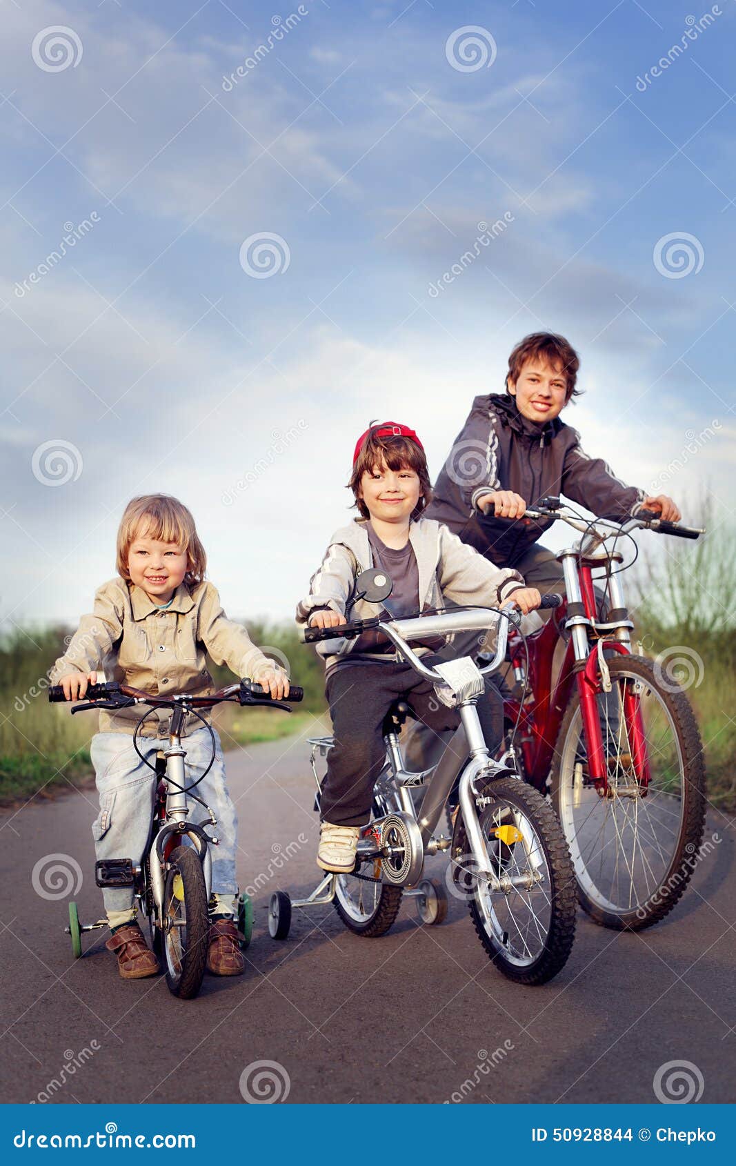 Three brothers ride bikes stock photo. Image of cycling - 50928844