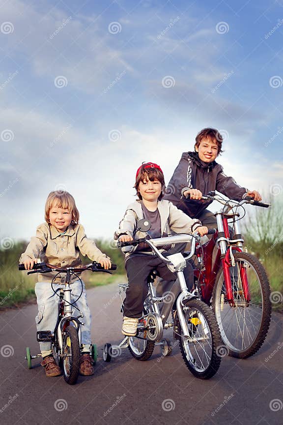 Three brothers ride bikes stock photo. Image of cycling - 50928844