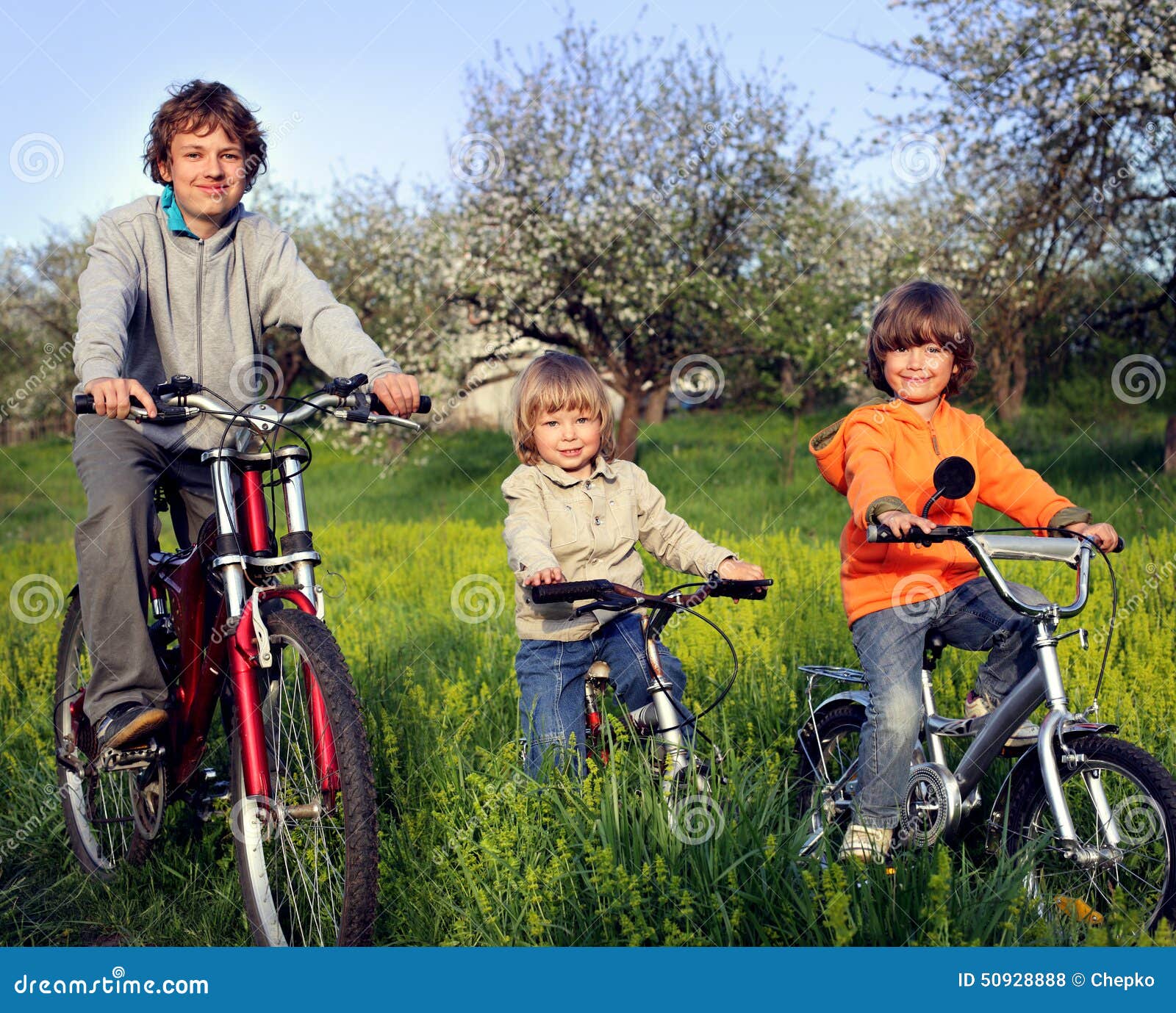 Three brothers ride bikes stock photo. Image of looking - 50928888