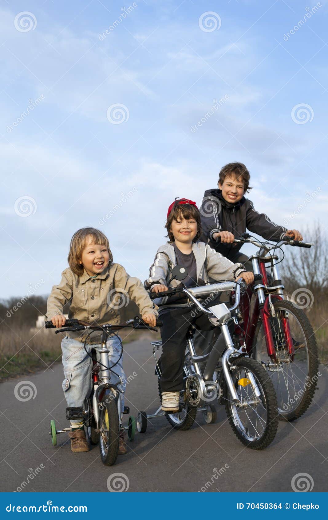 Three brothers ride bikes stock photo. Image of action - 70450364