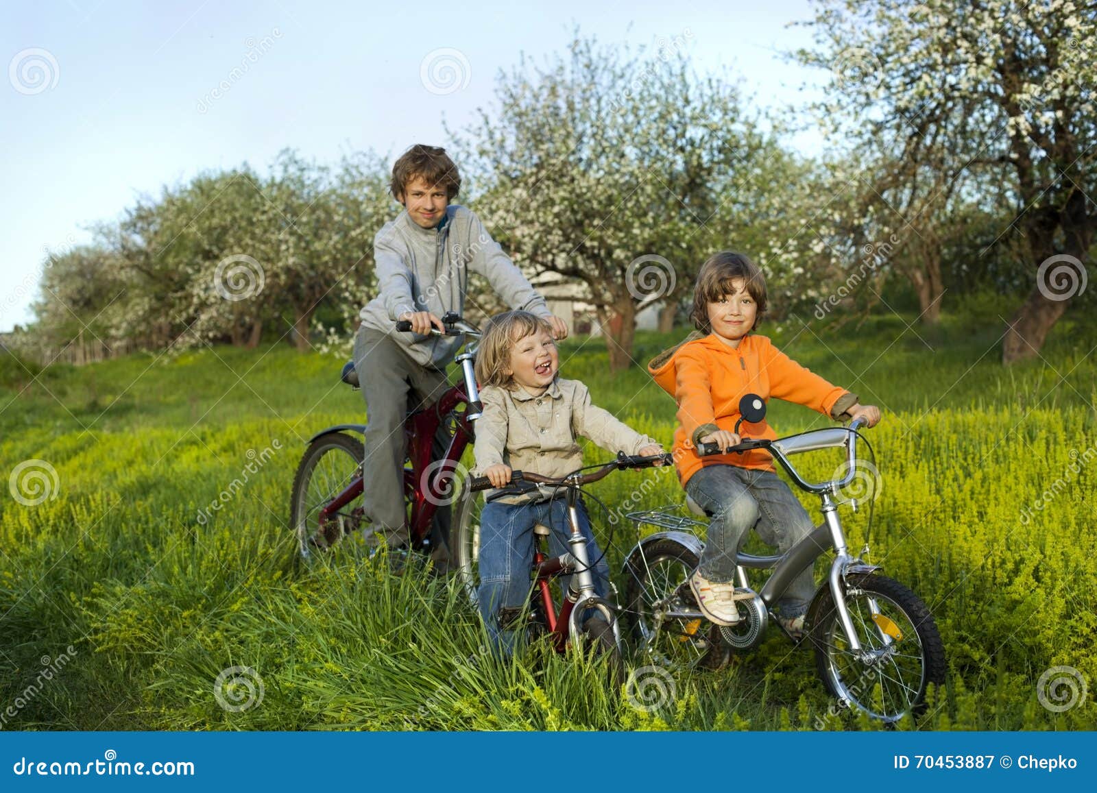 Three brothers ride bikes stock image. Image of action - 70453887