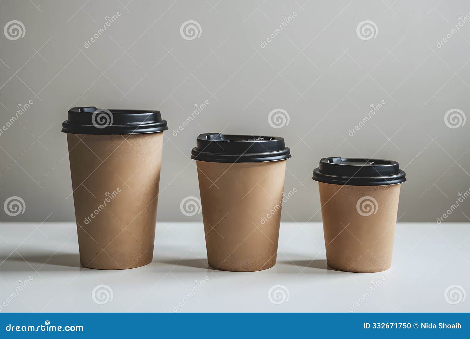 Three Brown Paper Cups with Black Lids in Different Sizes on White ...