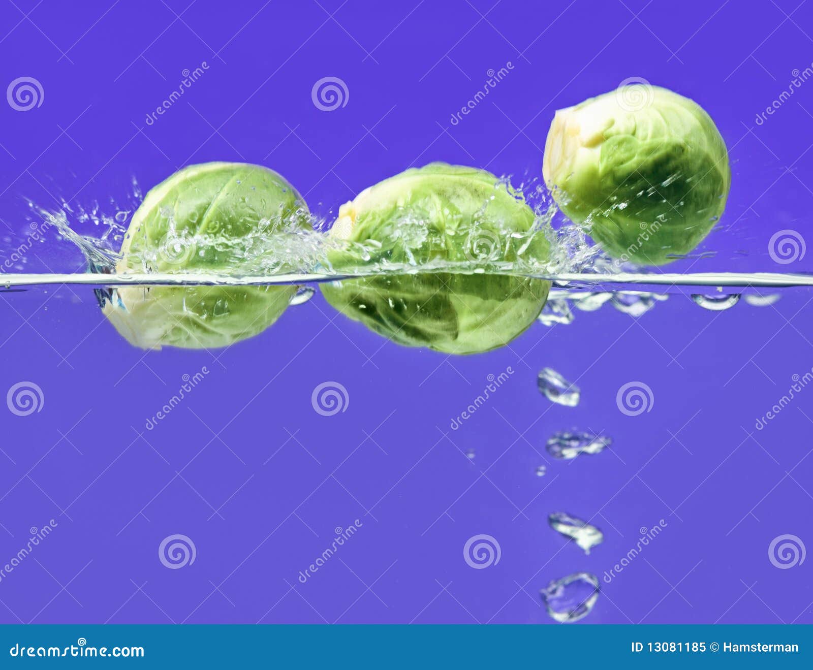 Three Brussels Sprouts Falling in Water Stock Image - Image of clear ...