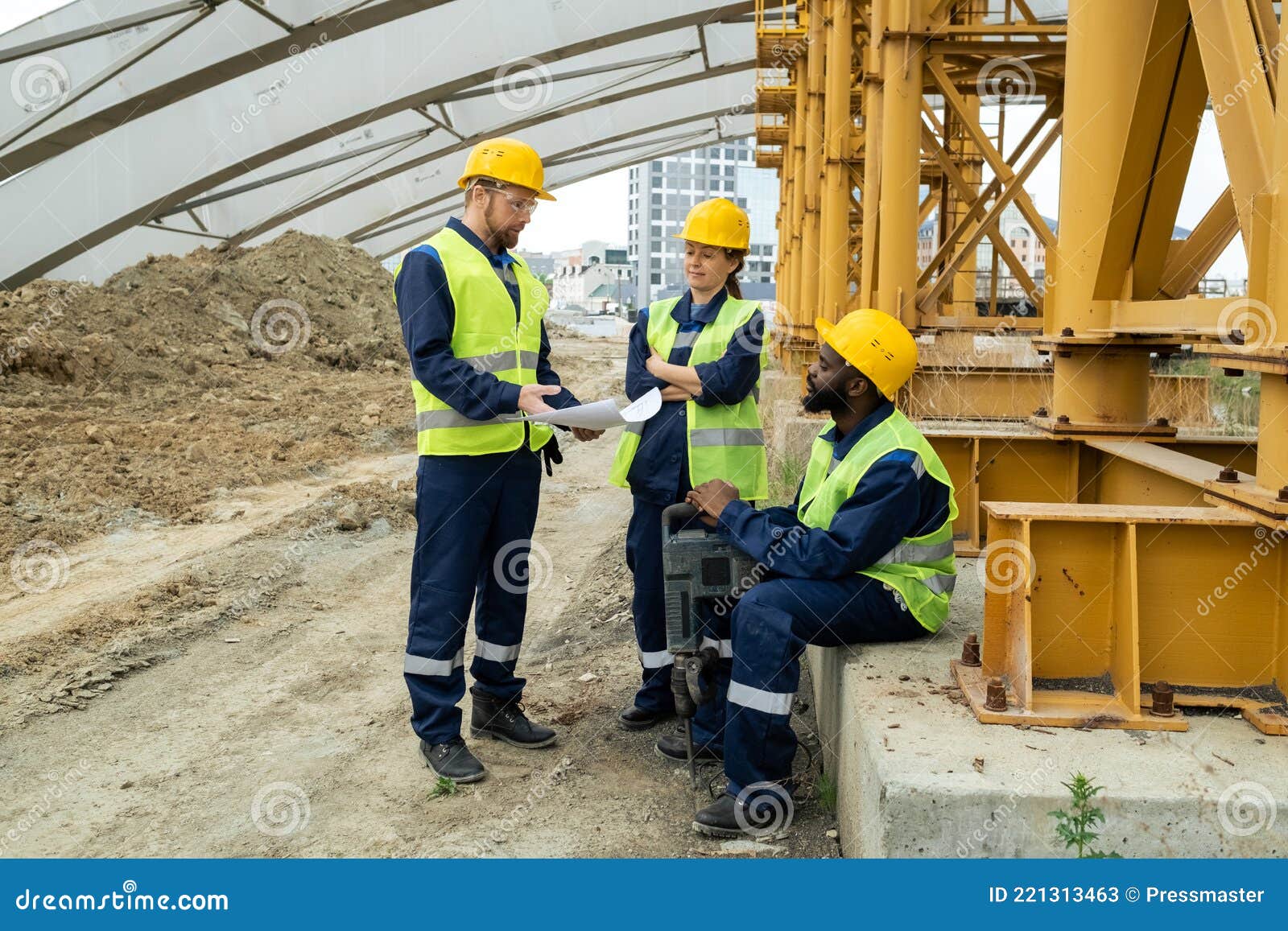 Three Builders Discussing Blueprint Outdoors Stock Image - Image of ...