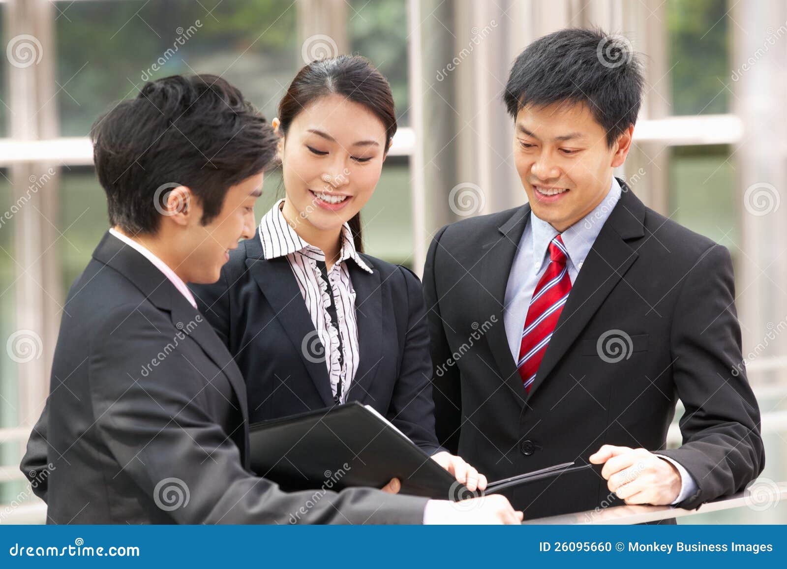 Three Business Colleagues Discussing Document Stock Photo - Image of ...