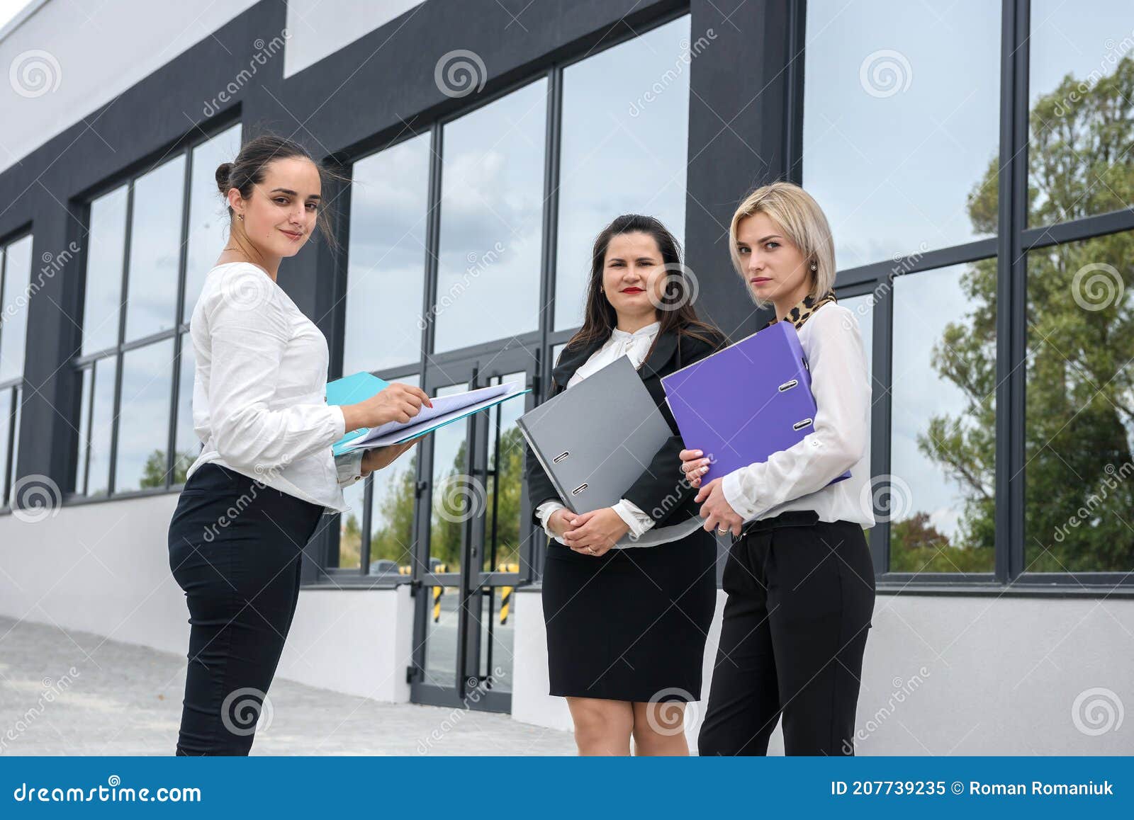 Three Business Colleagues Making Decision Outside Office Building Stock ...