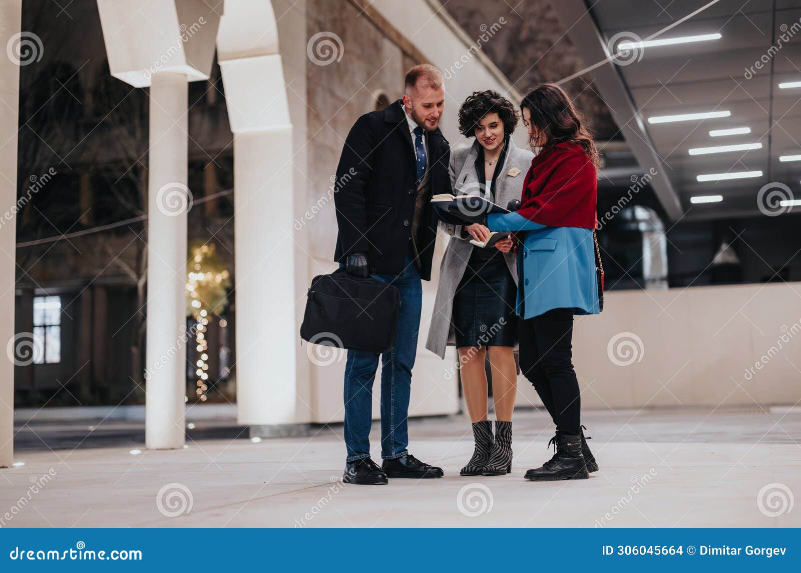 A Trio of Business Professionals Engaging in a Discussion Outside. they ...