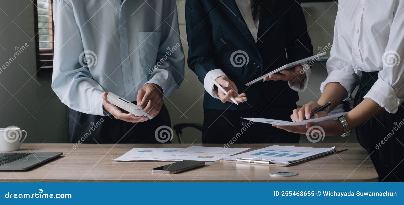 Three Business People with Busy Meetings in the Office. on the Table ...