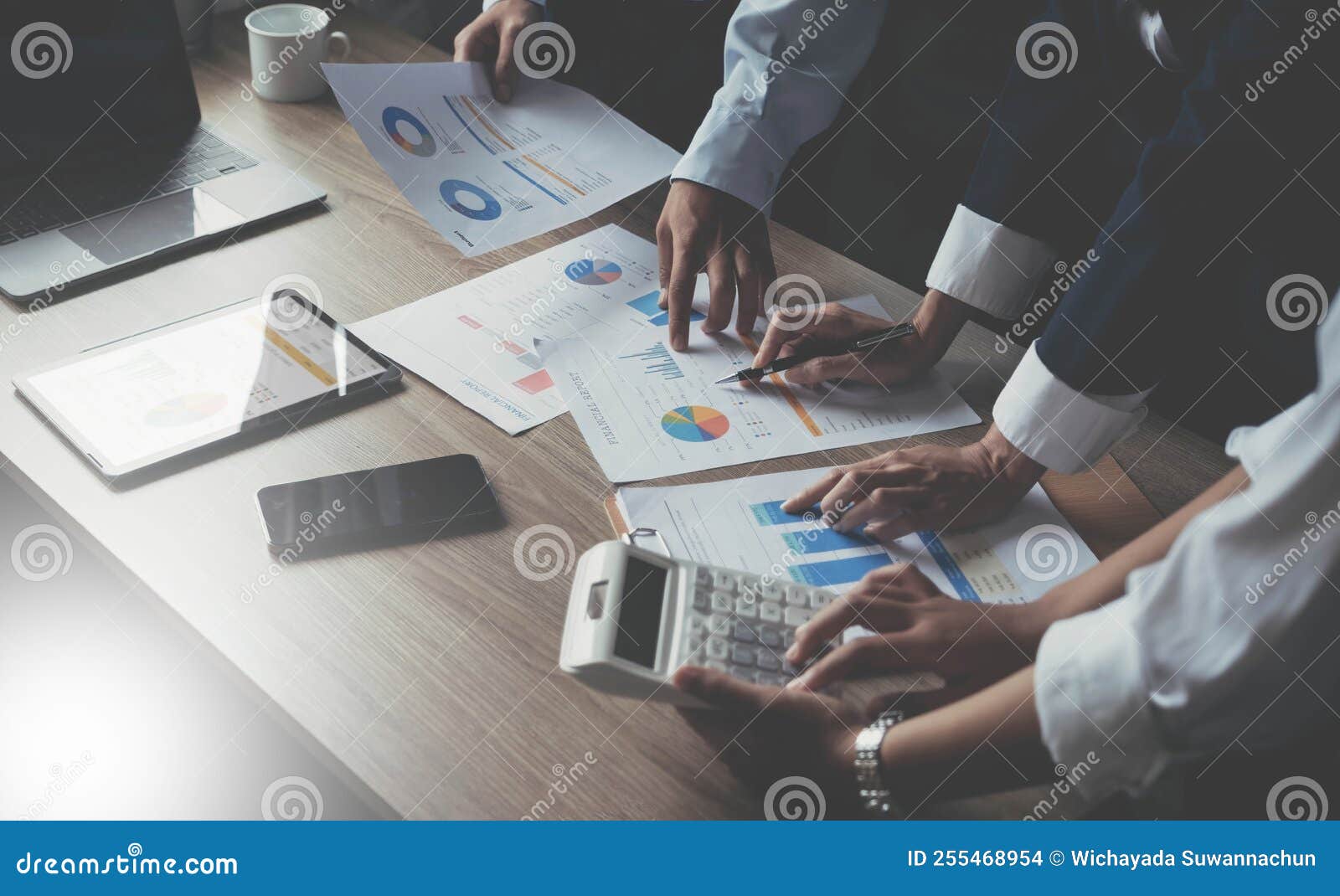 Three Business People with Busy Meetings in the Office. on the Table ...