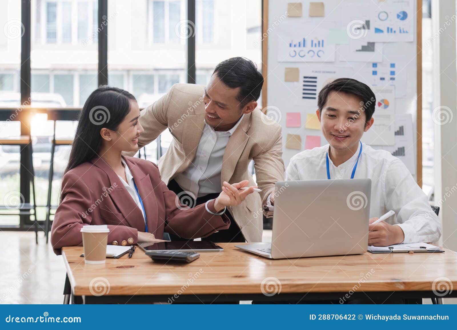 Three Business People are Enjoying Teamwork and Sharing Work Ideas ...