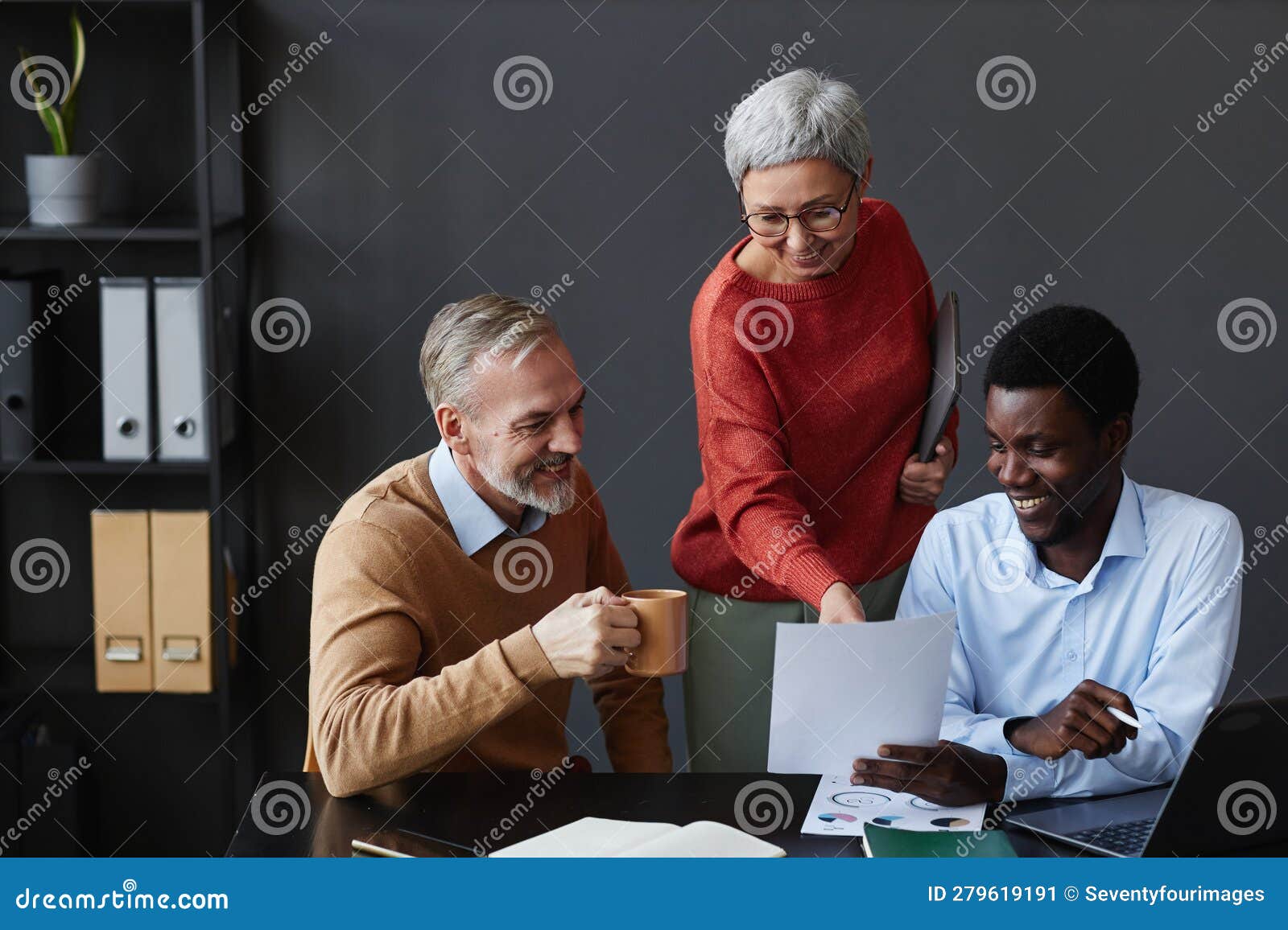 Three Business People with Senior Workers Collaborating Stock Image ...